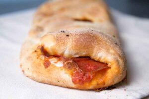 Folded Pizza Delight: Mouth-Watering Pepperoni Calzones Recipe – Urbaki ...